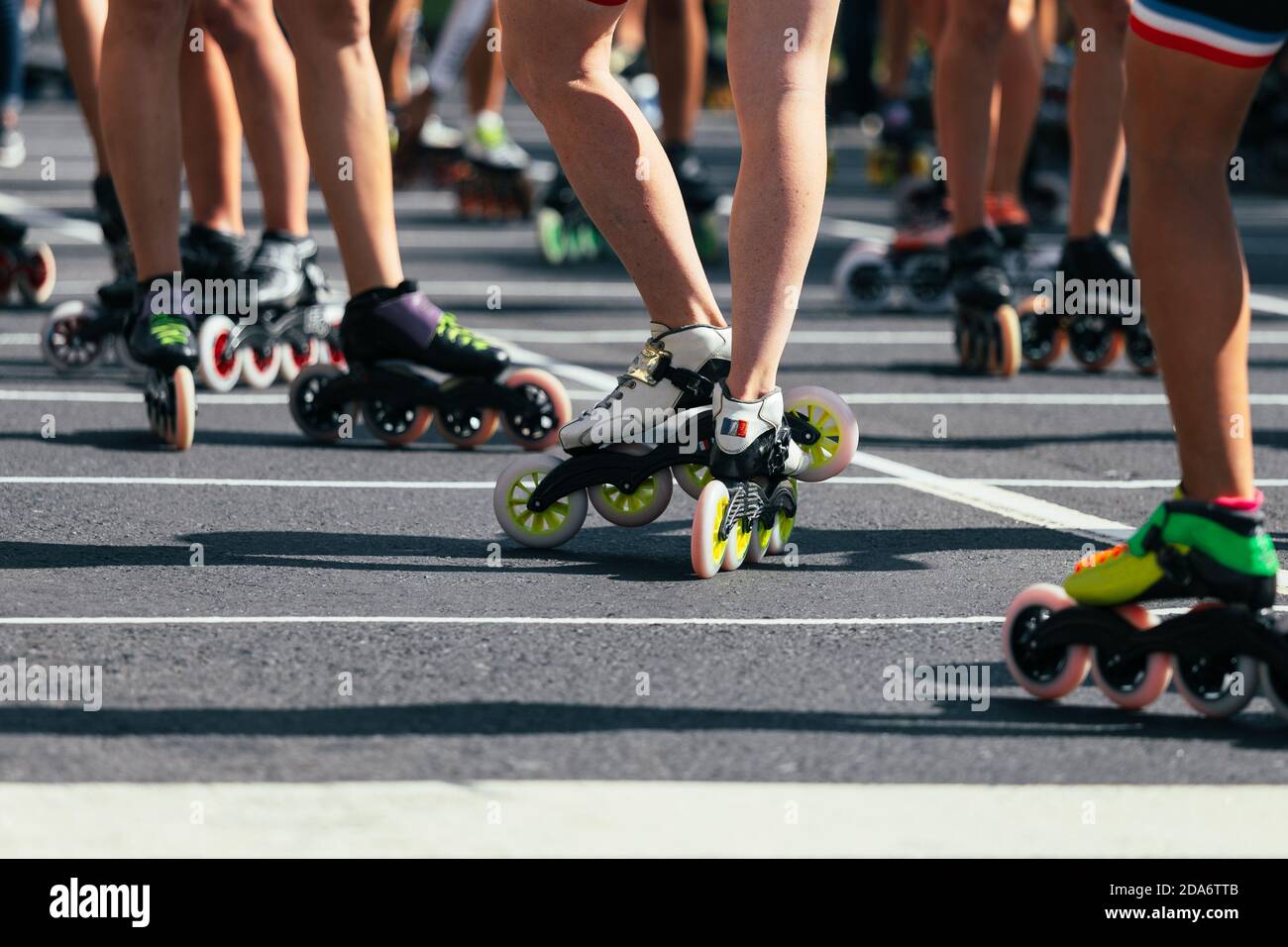 Group of people wearing inline roller skates Stock Photo - Alamy