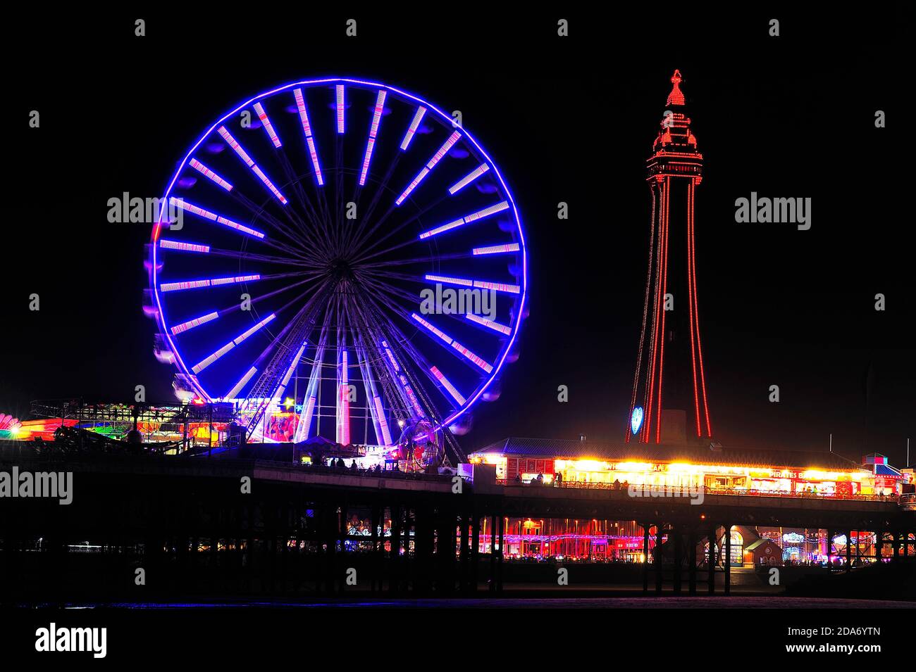The many colours of Blackpool Tower and the Ferris wheel at night ...
