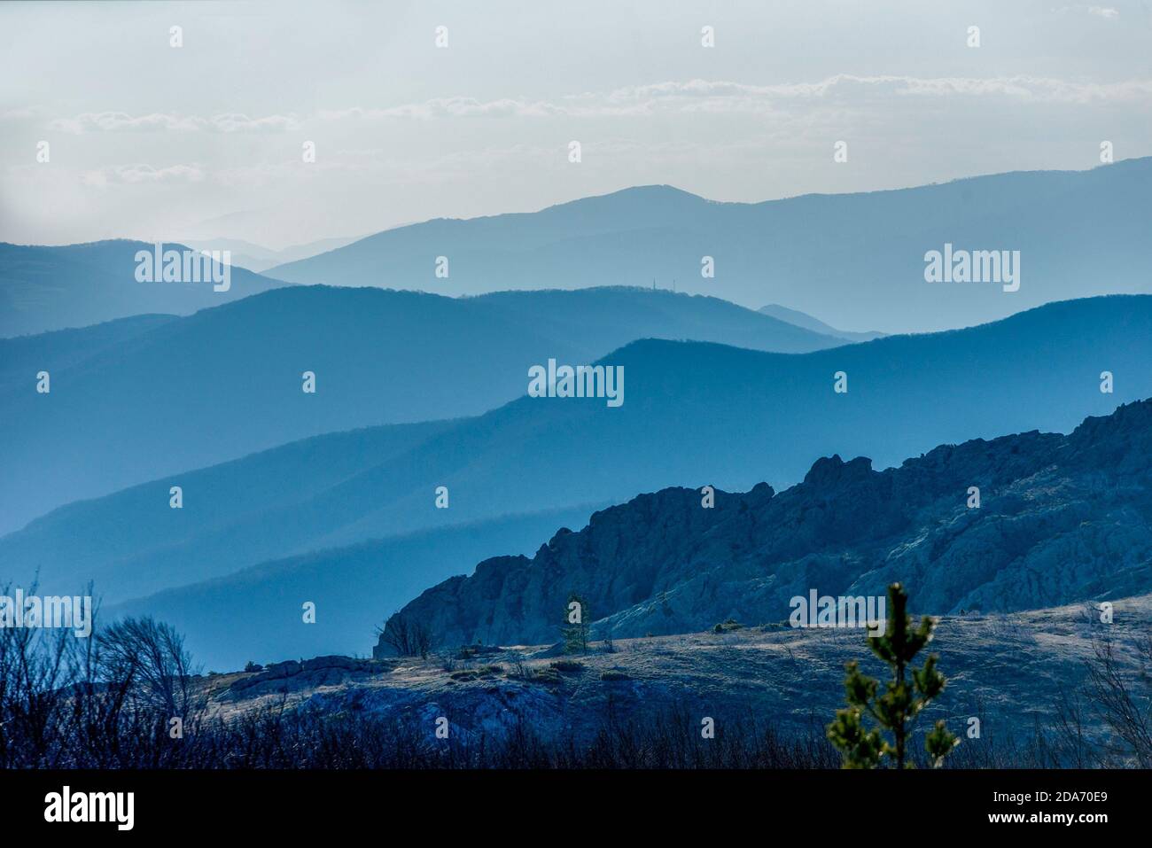 Layers of rolling hills in shades of green and blue in the distance ...