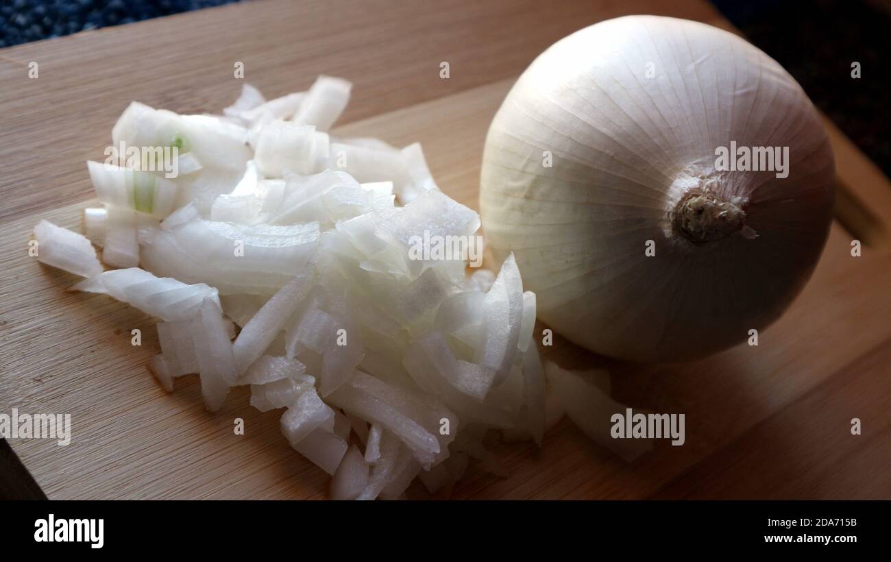 Chopped white onion on wood cutting board Stock Photo - Alamy