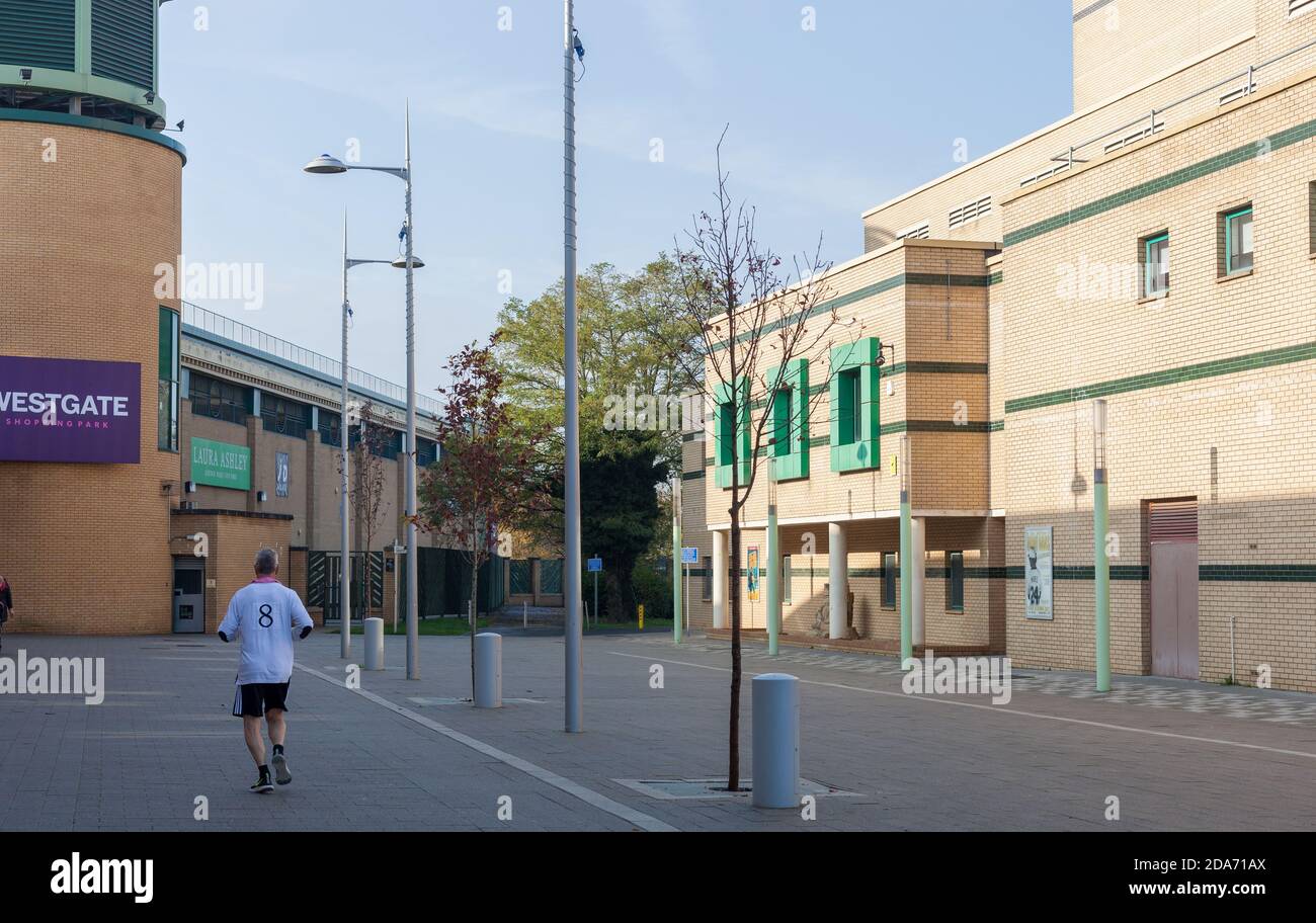 Rear view of a lone man running during National Lockdown near Westgate Park, Basildon Town ...