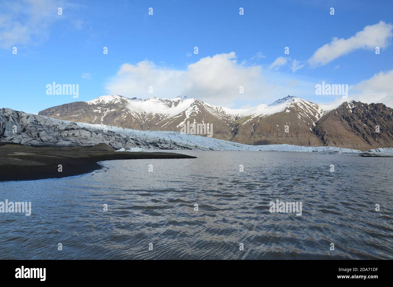 Iceland's glacial lake surrounded by volcanic mountain peaks Stock ...