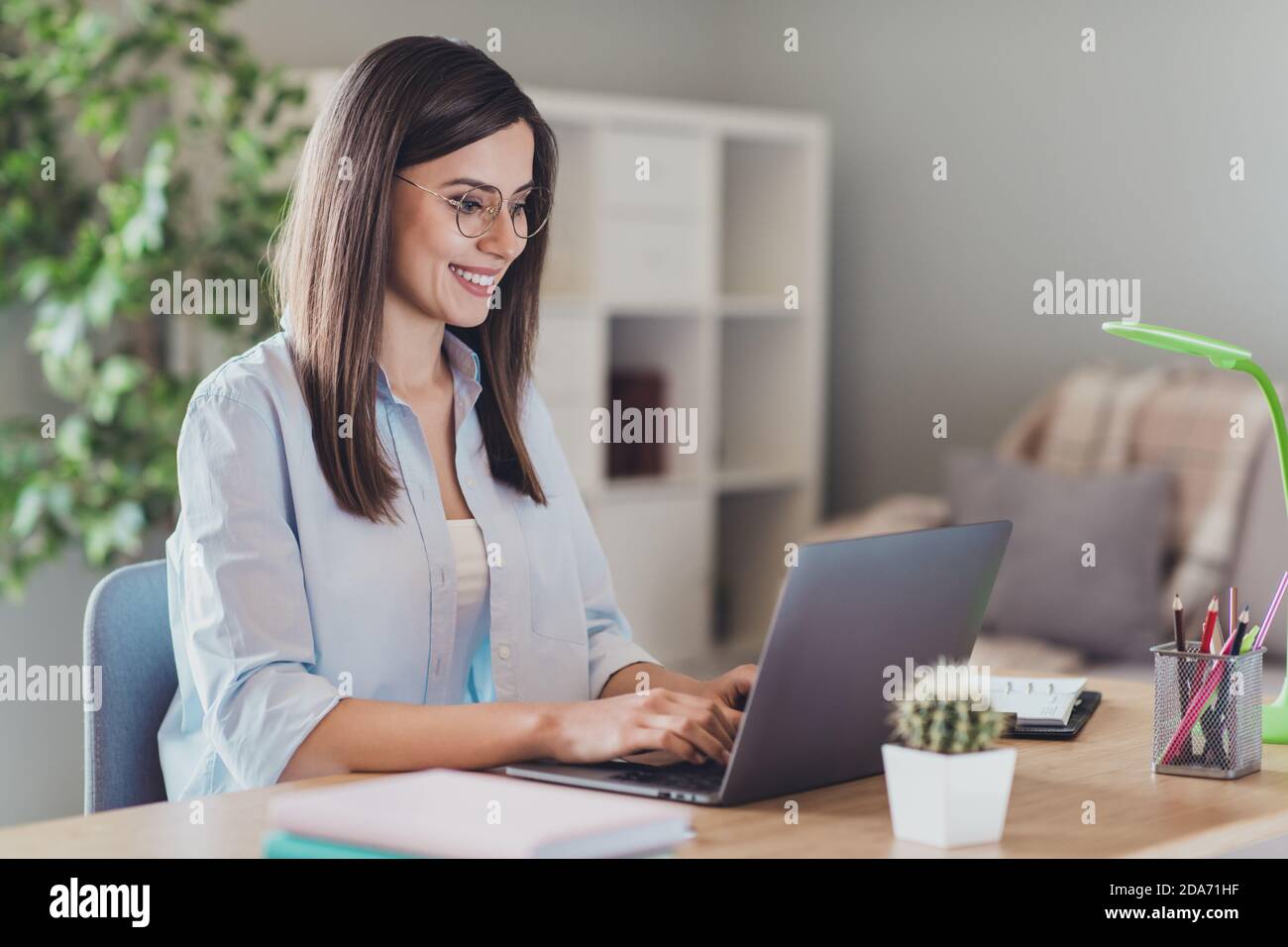 Photo of charming young girl sit chair arms typing keyboard netbook ...
