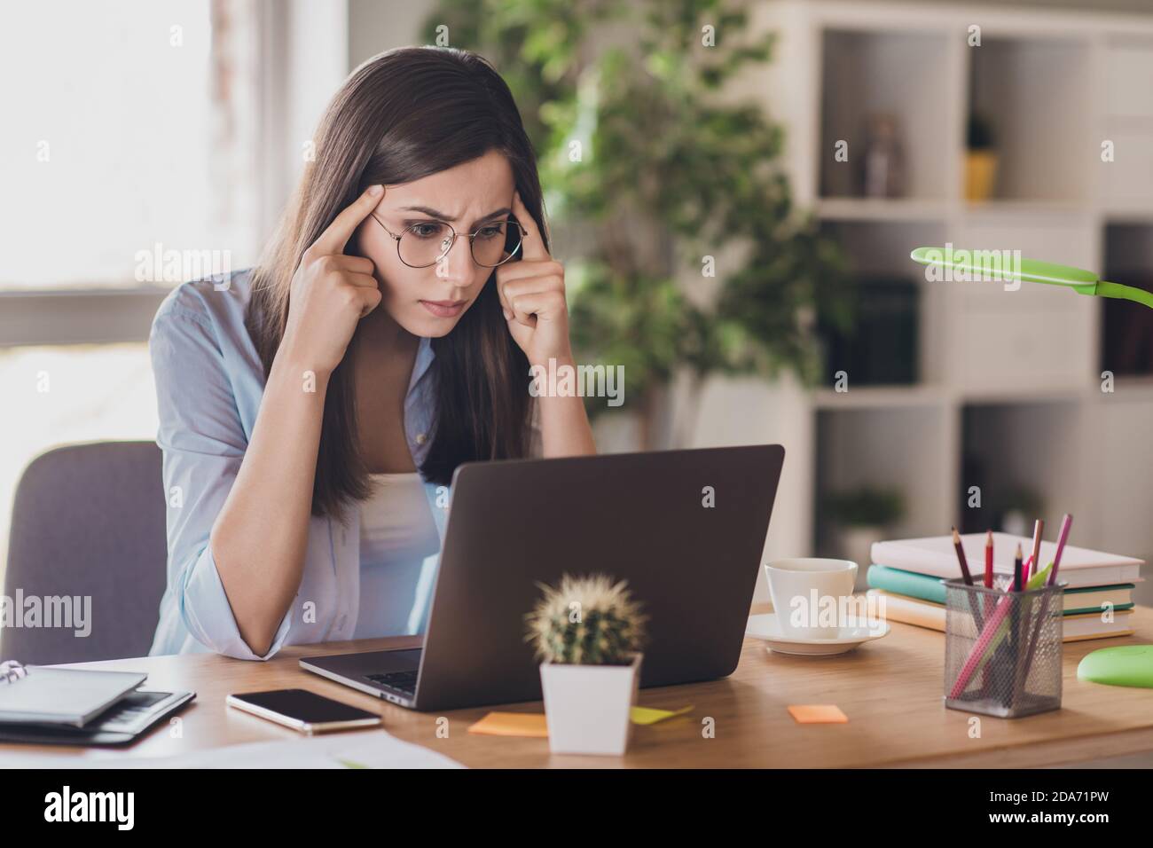 Photo of minded concentrated lady fingers head think look computer wear ...