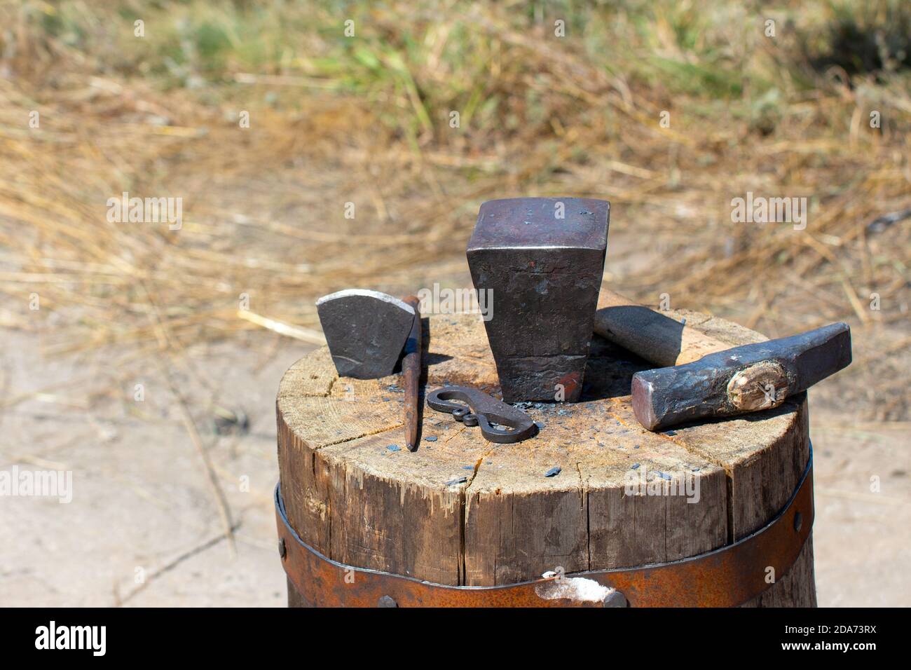 The old tools of a blacksmith on large wooden stump Stock Photo - Alamy