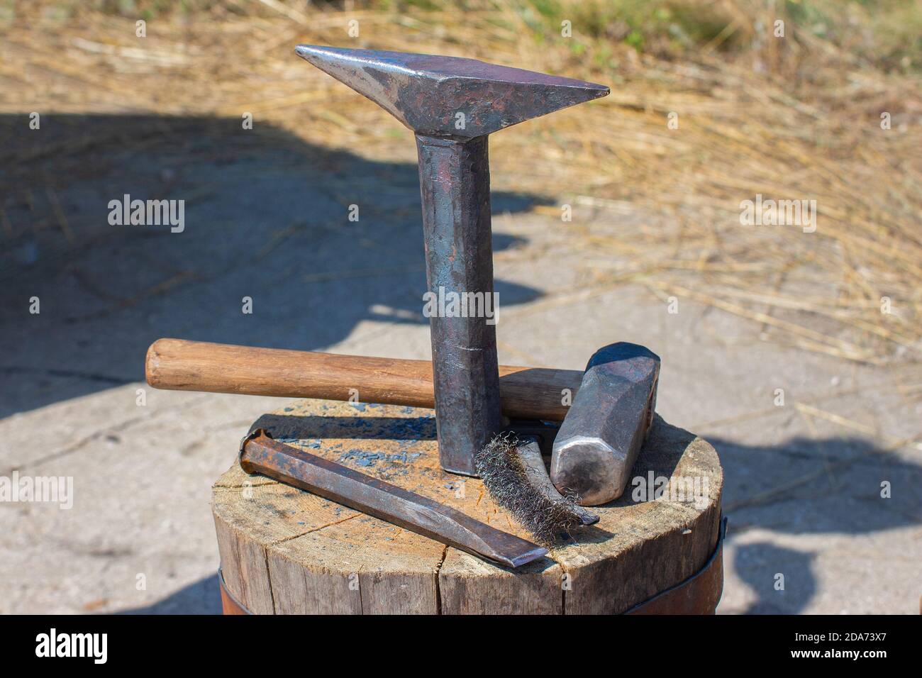 The old tools of a blacksmith on large wooden stump Stock Photo - Alamy