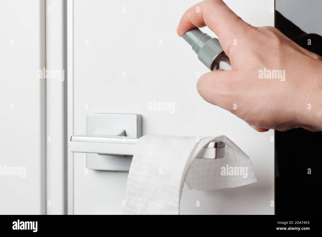 Cleaning white metal door handle with spray macro close up view Stock ...