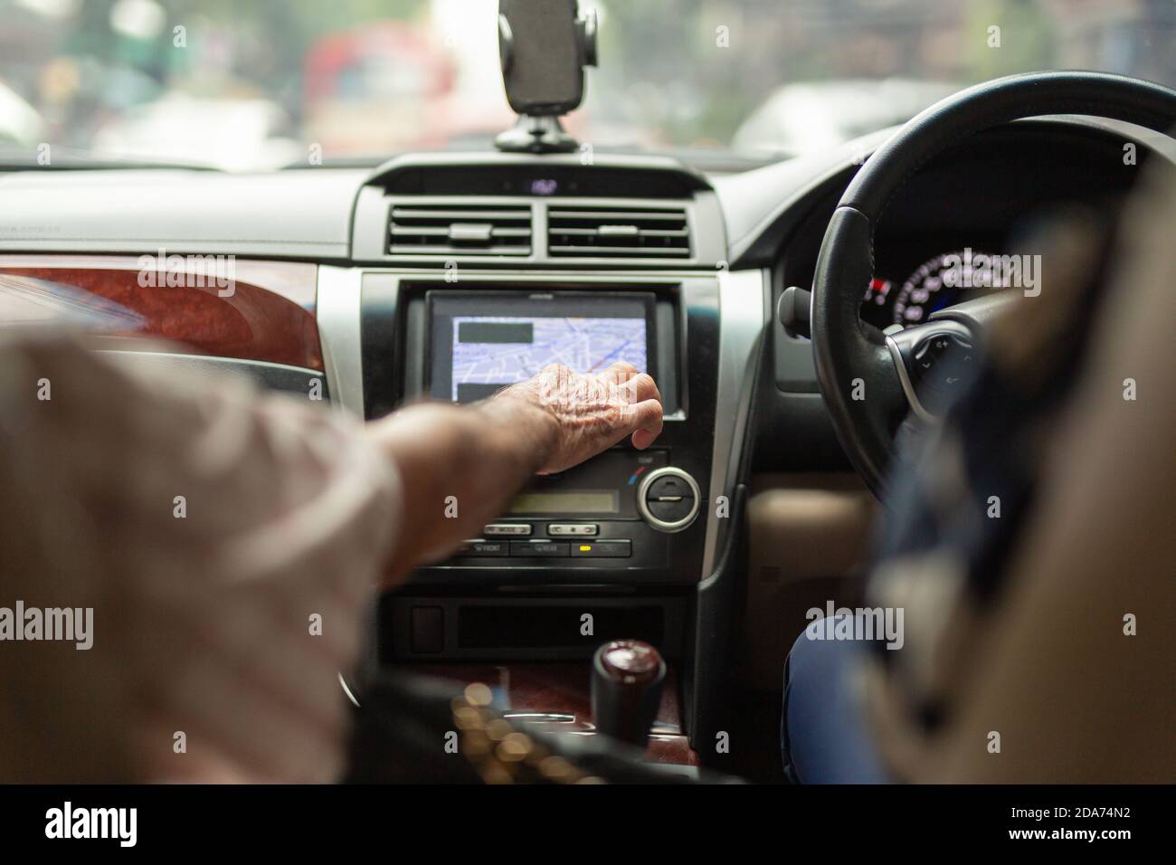Father hand using car system control on touch screen while daughter ...