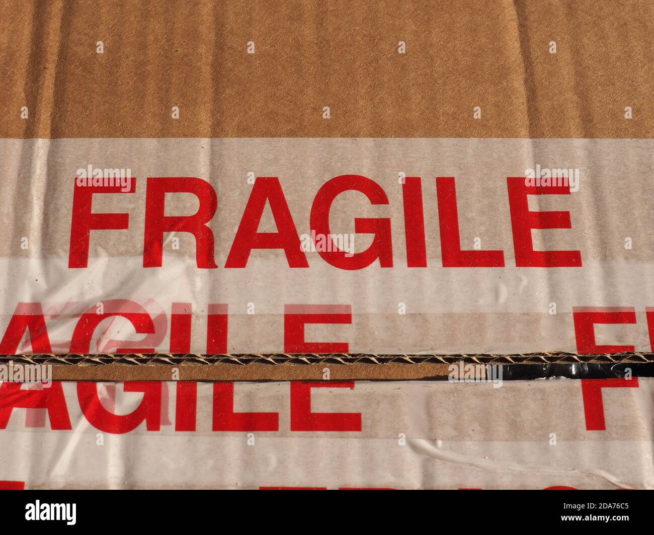 Fragile warning tape on corrugated cardboard box Stock Photo - Alamy