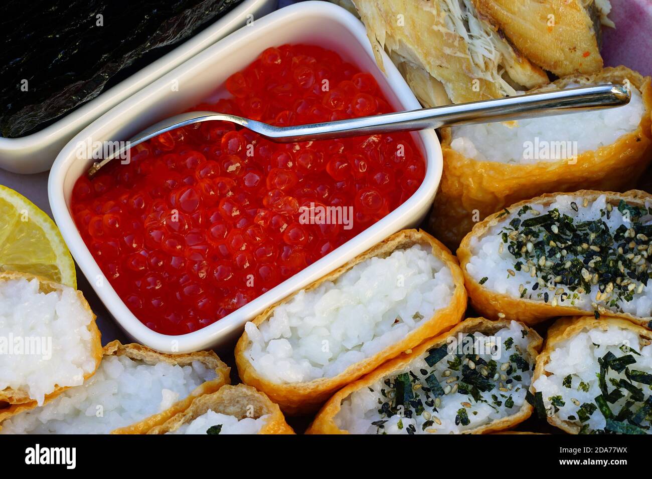 Inari rolls, tofu skins stuffed with sushi rice, with ikura salmon roe ...