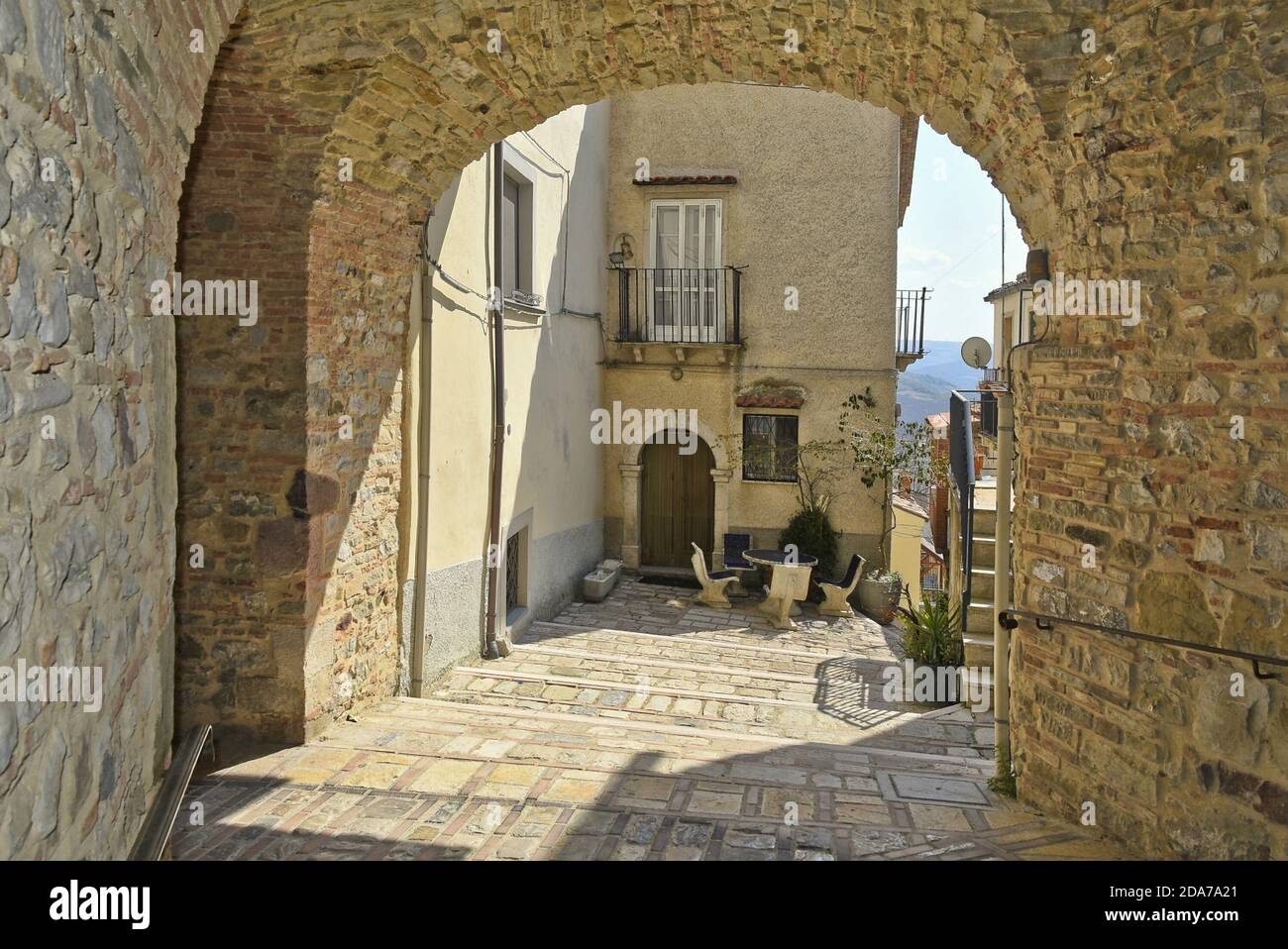 A narrow street among the old houses of San Bartolomeo in Galdo, a ...