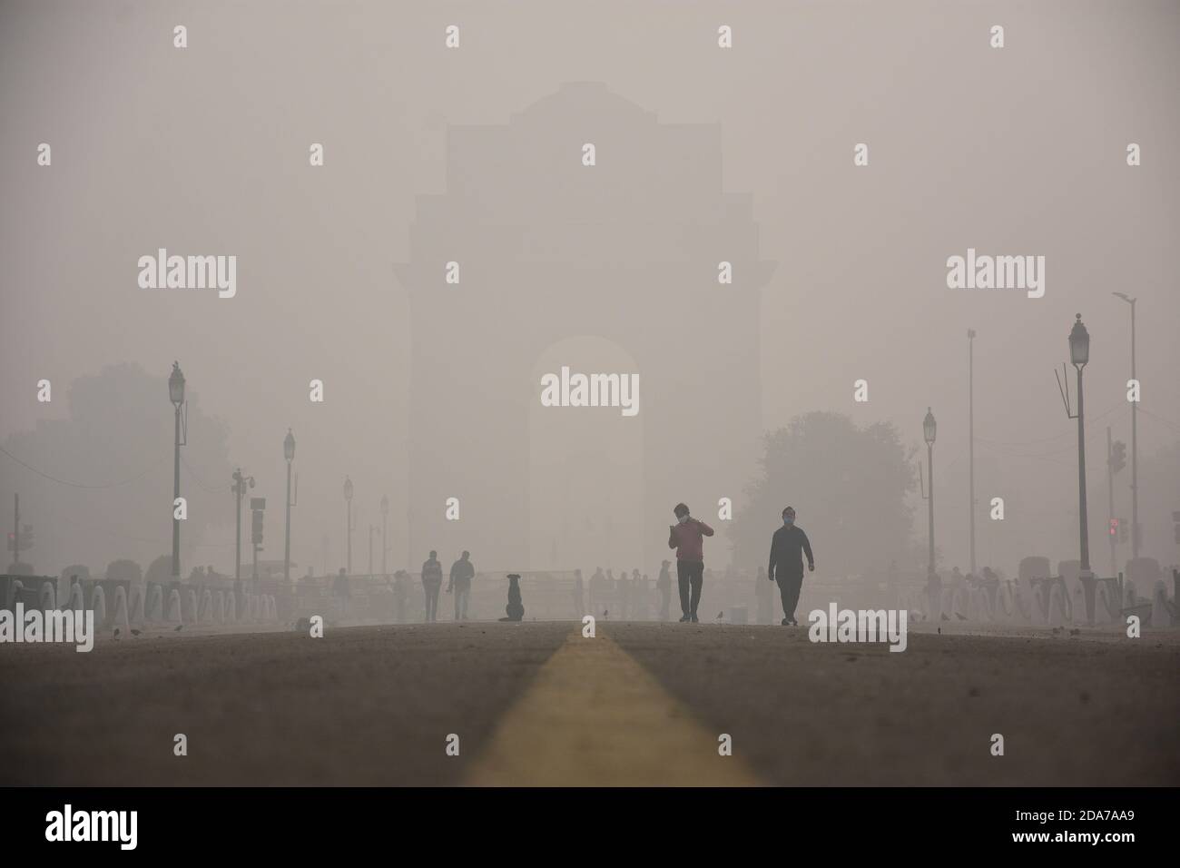 People walk near India gate amid heavy smog in New Delhi. According to ...