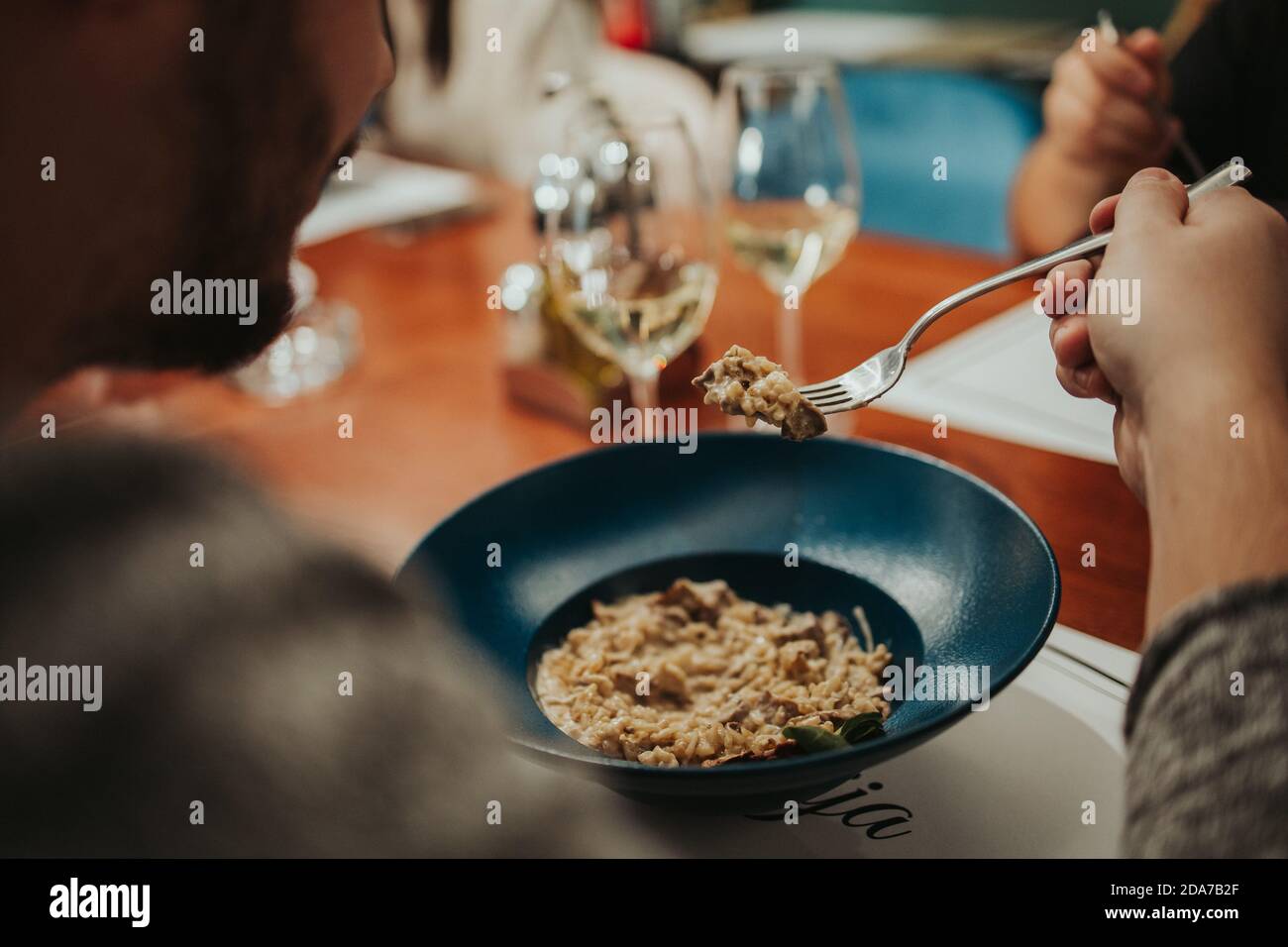 High angle shot of a person eating a dish in the restaurant Stock Photo ...