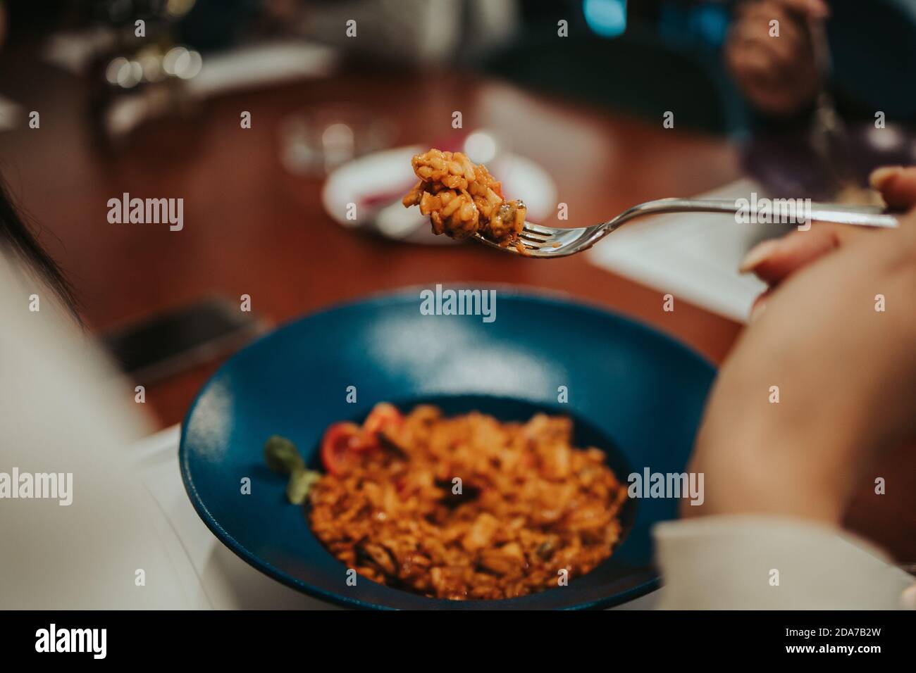 High angle shot of a person eating a dish in the restaurant Stock Photo ...