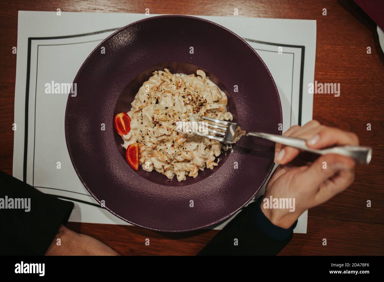 High angle shot of a person eating a dish in the restaurant Stock Photo ...