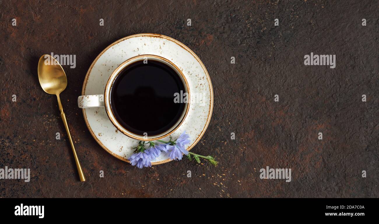 Chicory drink, golden color spoon and chicory flower on dark brown ...