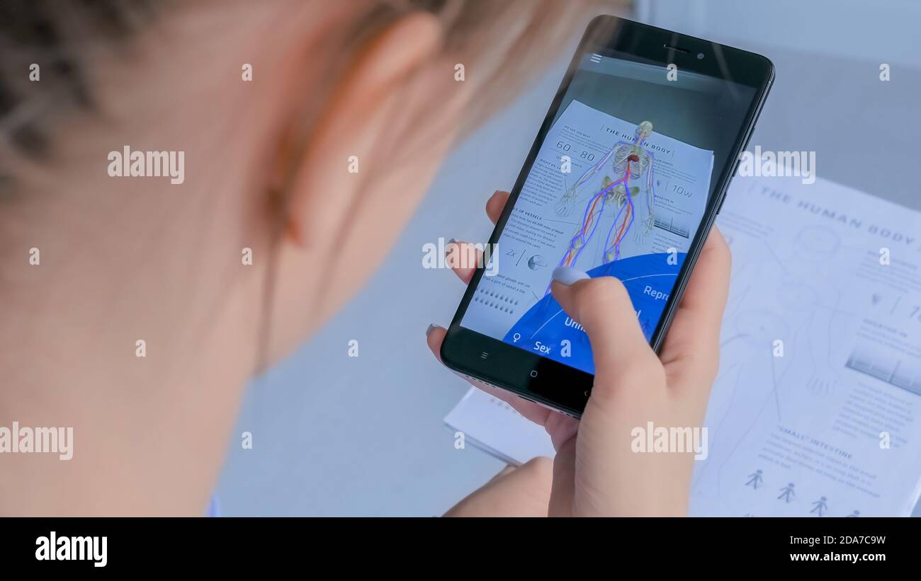 MOSCOW, RUSSIA - AUGUST 1, 2019. Woman using smartphone with augmented ...