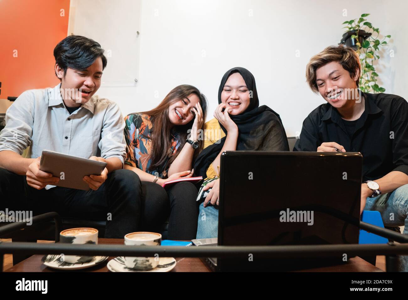 Group of smiling teenagers staying together when work assignment ...