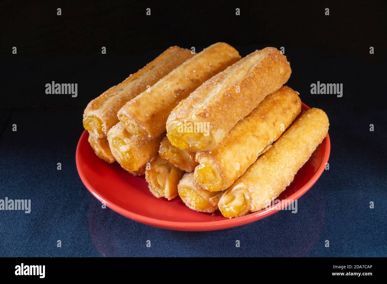 The Sweet sticks with stuffing in red plate on black background ...