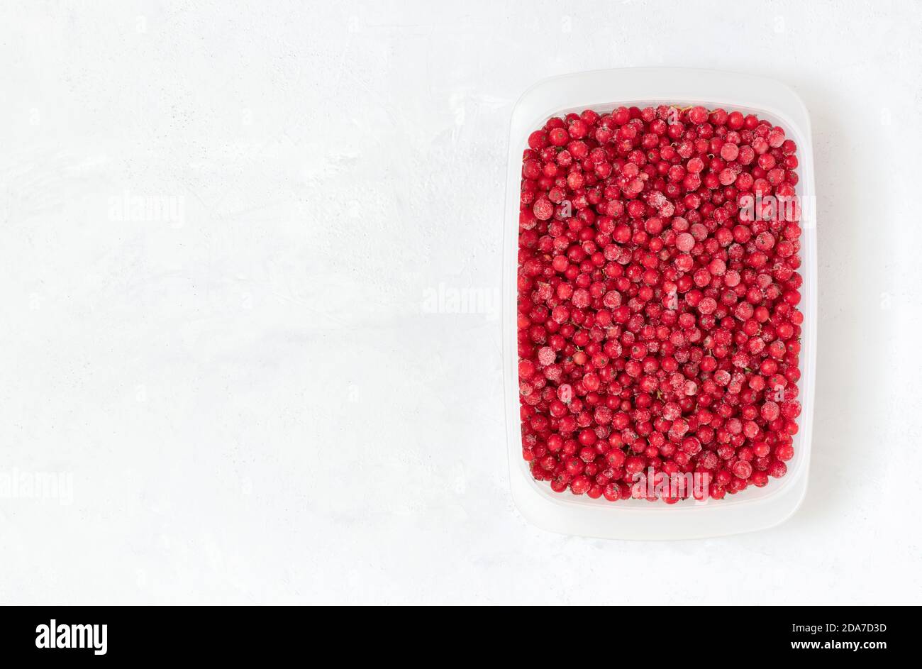 Frozen red currant in a container on a white background. Storage of ...