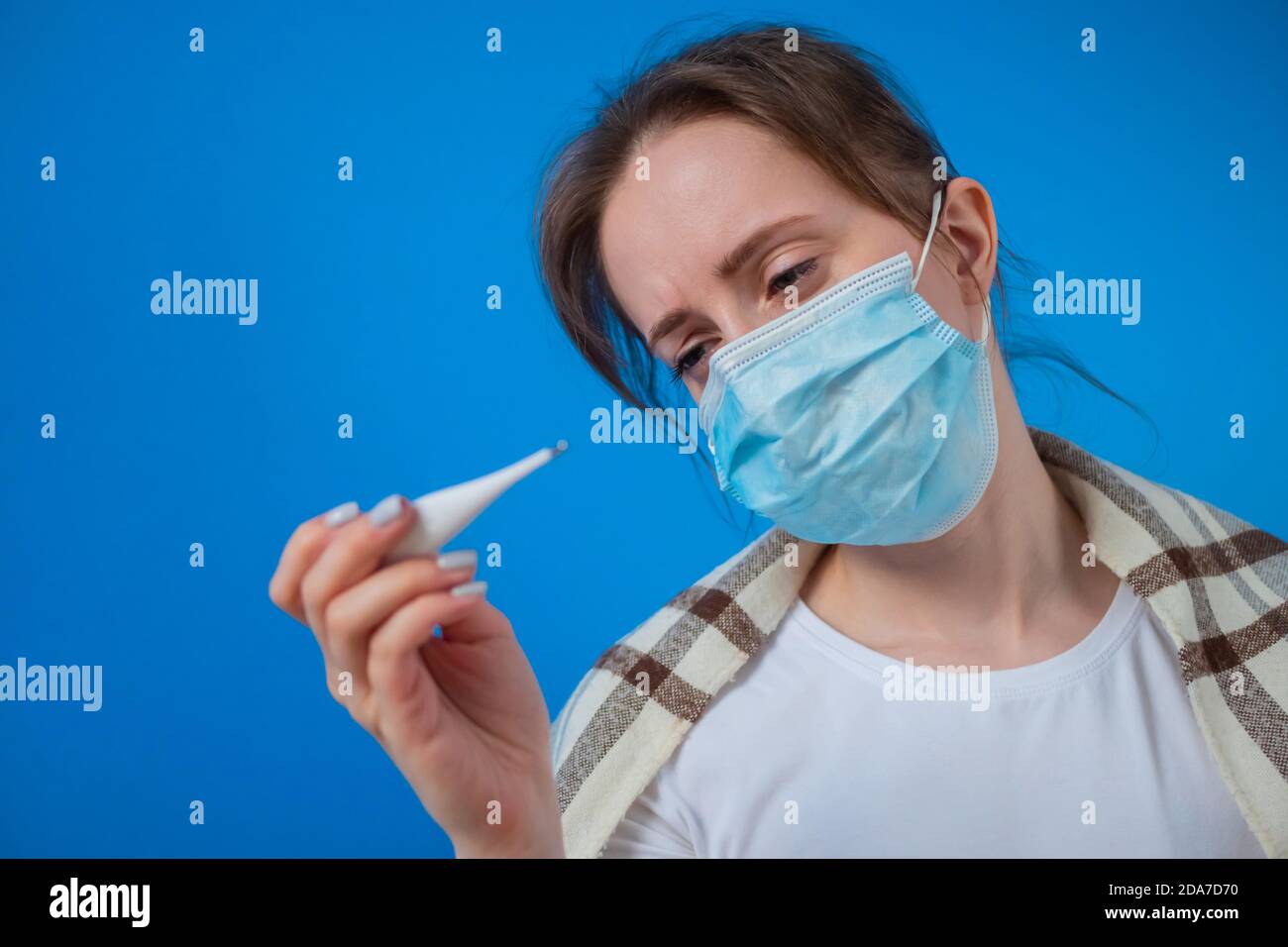 Woman feeling sick, looking at digital medical thermometer with high ...