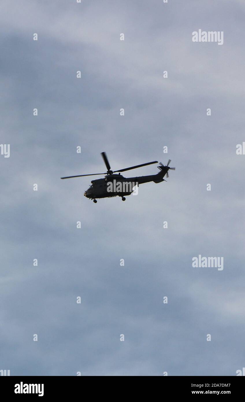 Grey Airbus Super Puma H215 Search and Rescue helicopter flying along ...