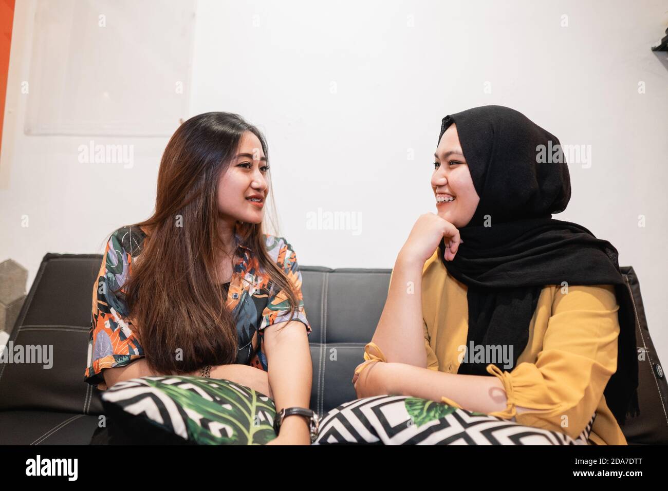 two asian young girls chatting while sitting in a coffee shop Stock ...