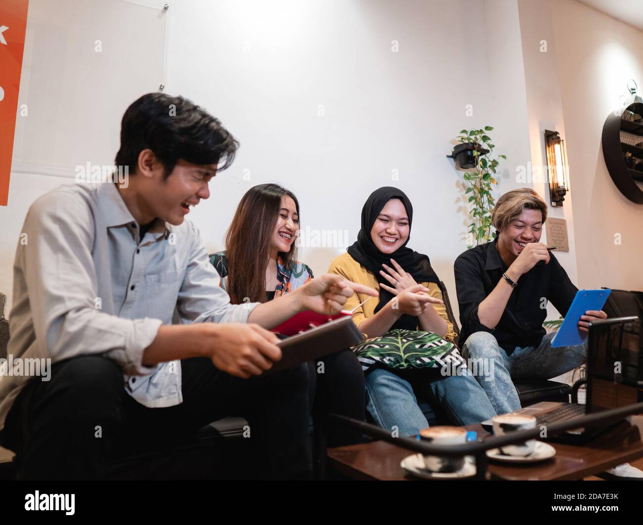 Group of smiling teenagers staying together when work assignment ...