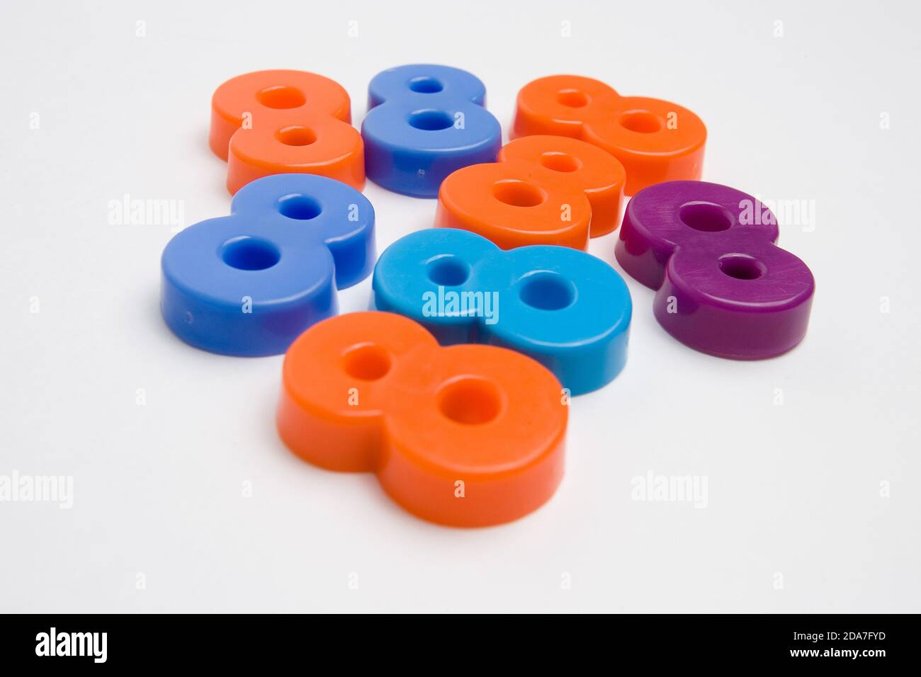 Colourful plastic fridge magnet style numbers and symbols still life ...