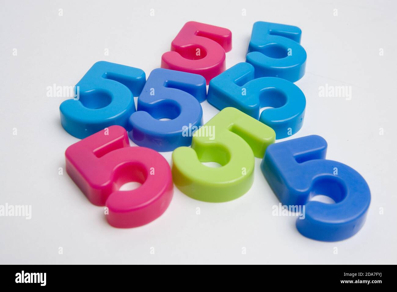 Colourful plastic fridge magnet style numbers and symbols still life ...