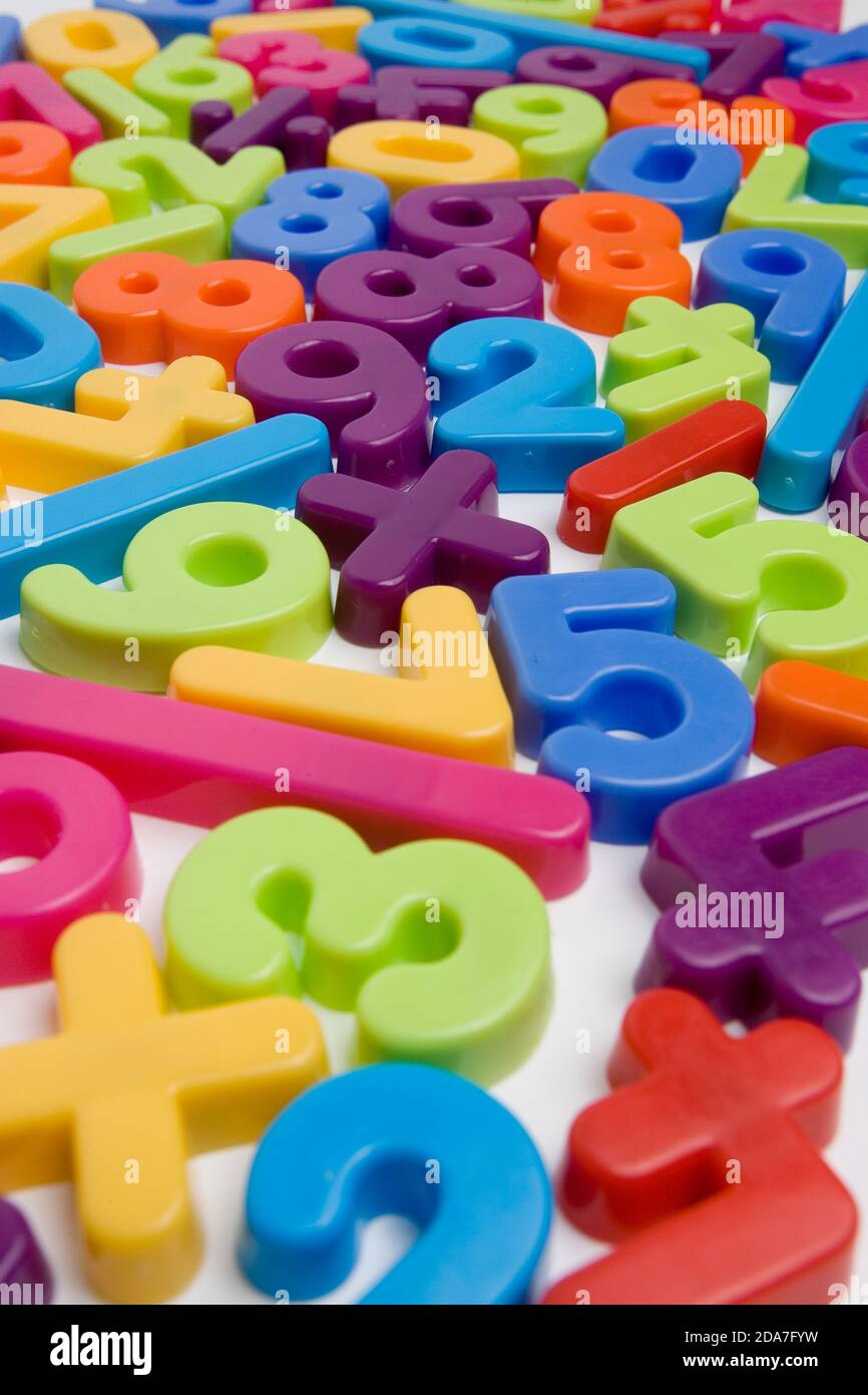 Colourful plastic fridge magnet style numbers and symbols still life ...
