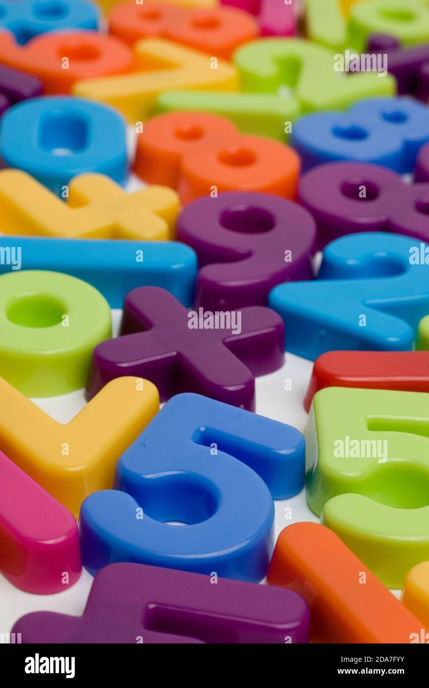 Colourful plastic fridge magnet style numbers and symbols still life ...