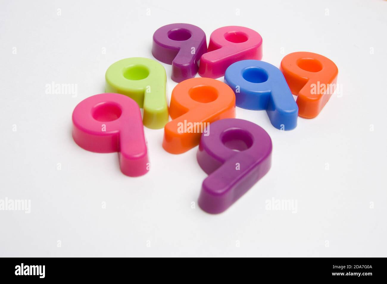 Colourful plastic fridge magnet style numbers and symbols still life ...