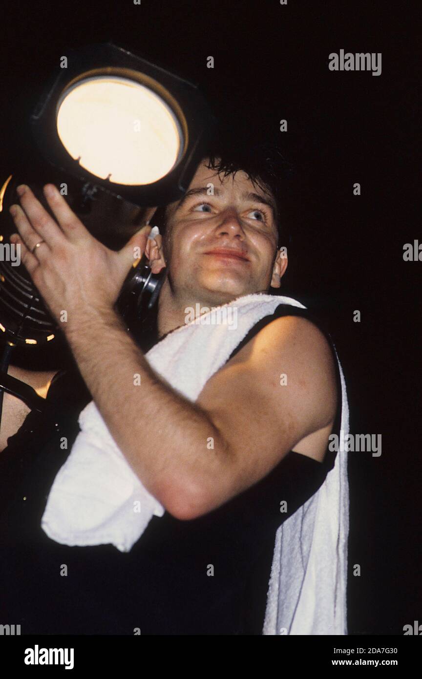 U2's Bono performing live at a concert on The Unforgettable Fire tour ...