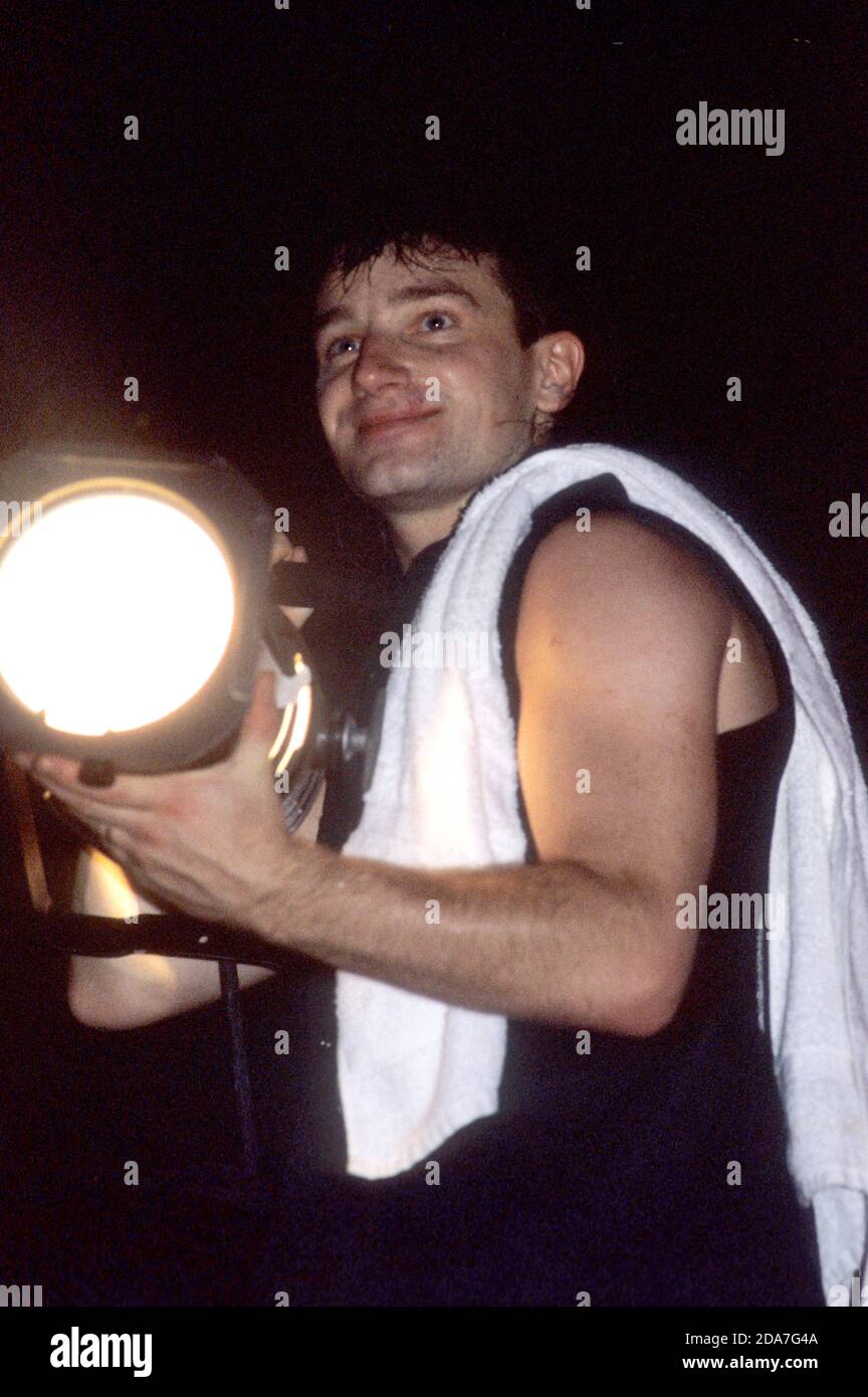 U2's Bono performing live at a concert on The Unforgettable Fire tour ...