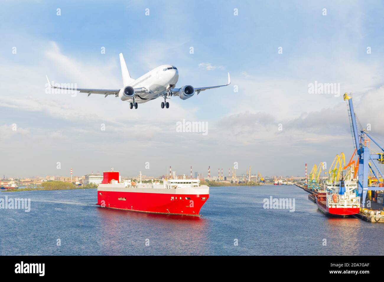 Aircraft landing approach over the cargo seaport Stock Photo - Alamy