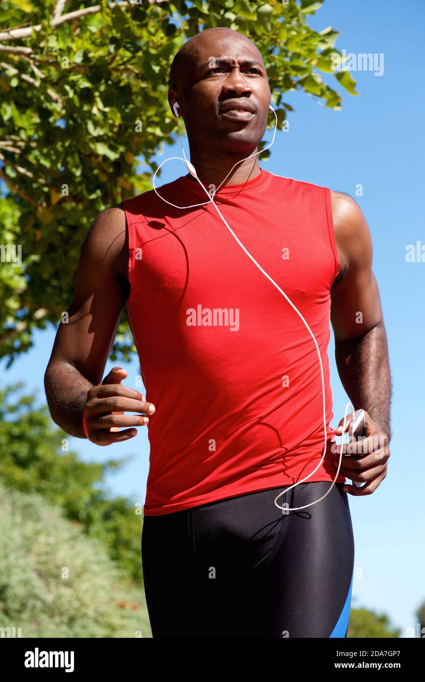 Portrait of fit young man running outside Stock Photo - Alamy