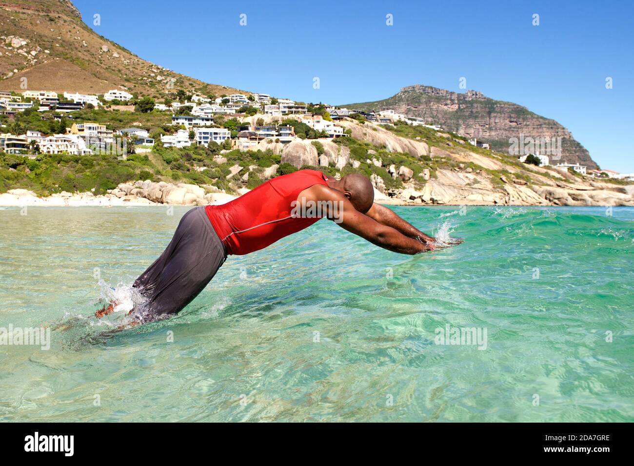 Side portrait of young african american man diving into sea Stock Photo ...