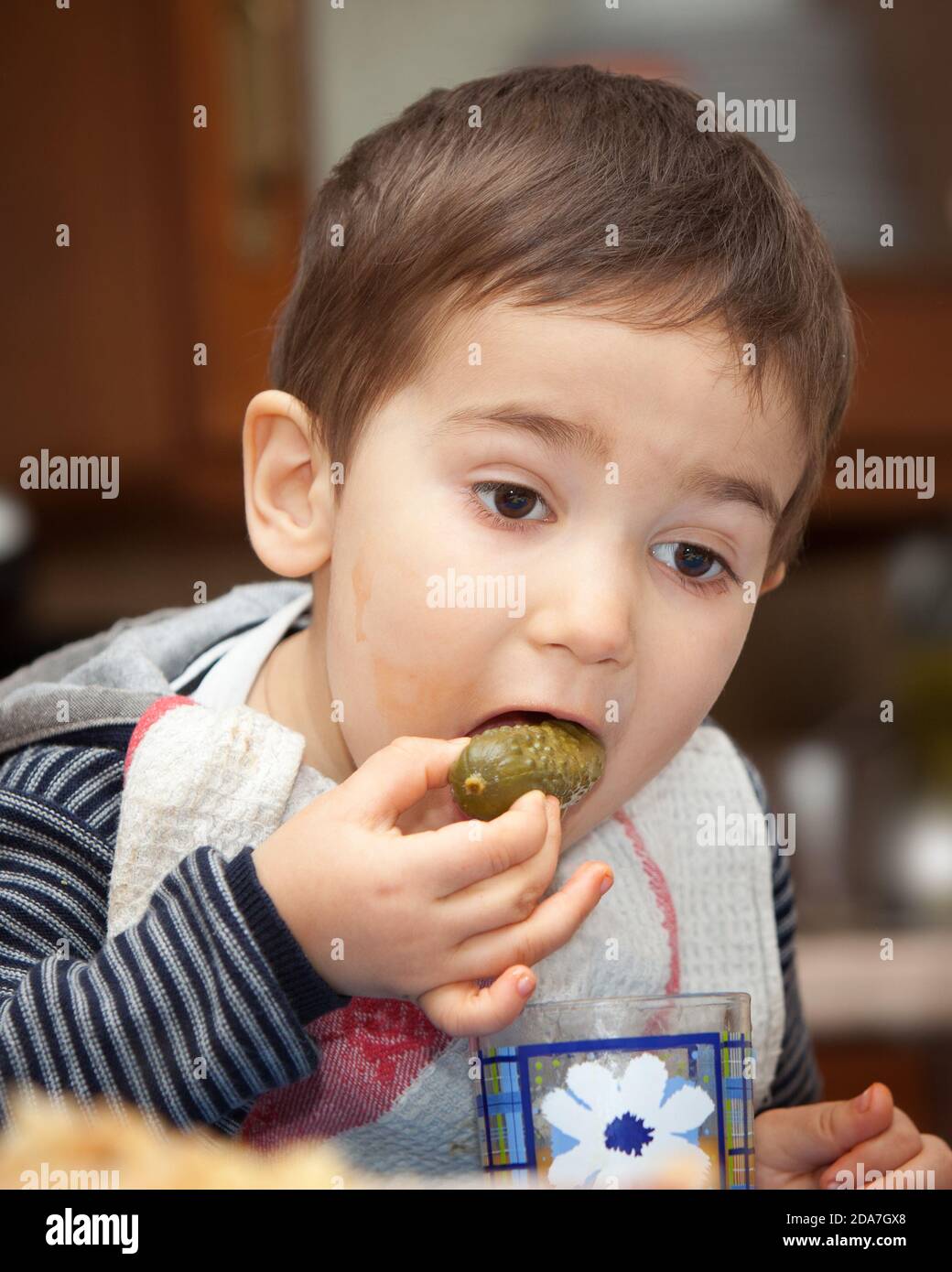 Little boy eats pickles Stock Photo - Alamy