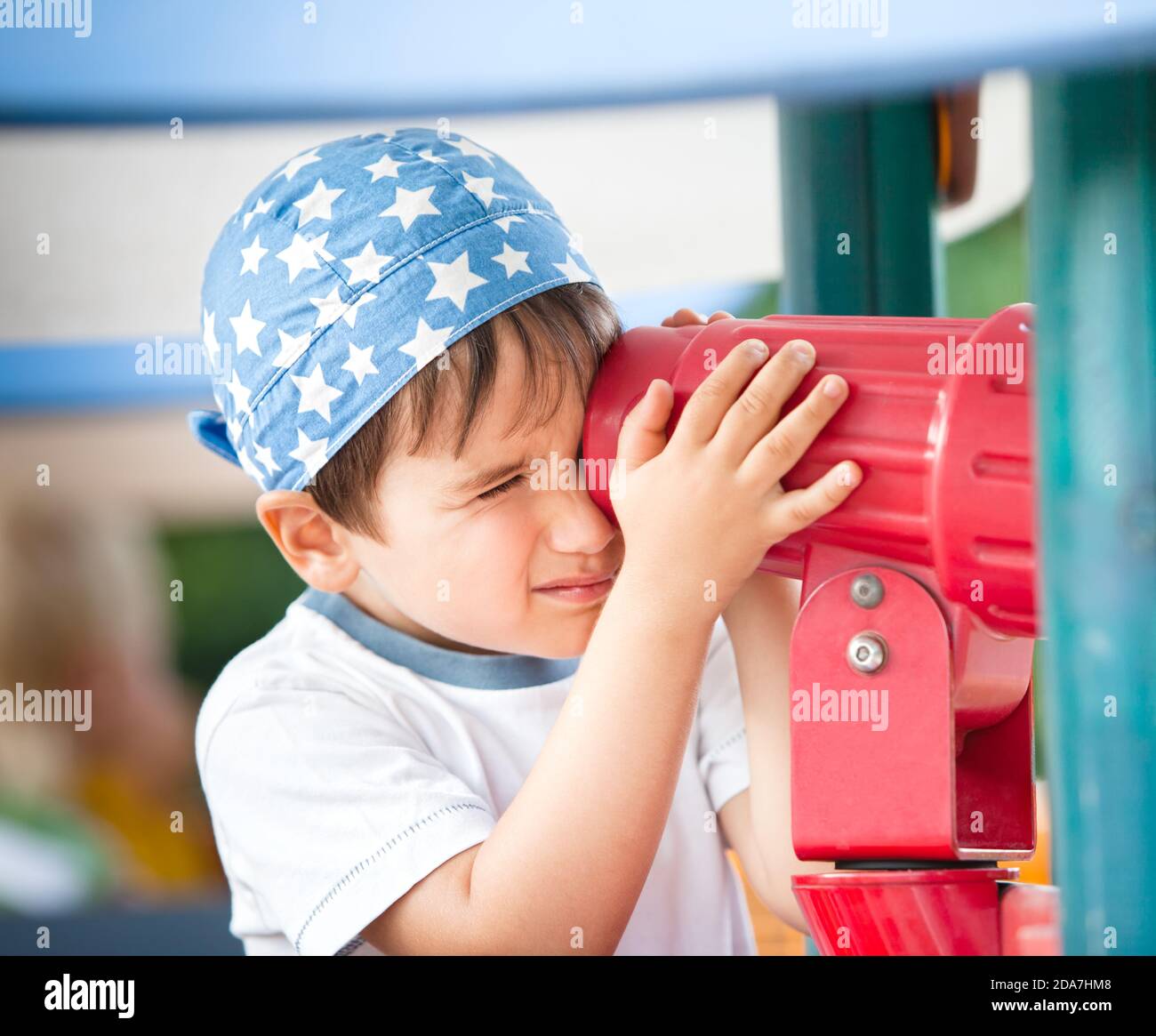 Little boy playing with a toy telescope at the playground Stock Photo ...