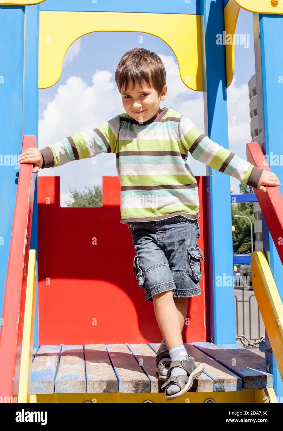 cute boy standing on playground Stock Photo - Alamy