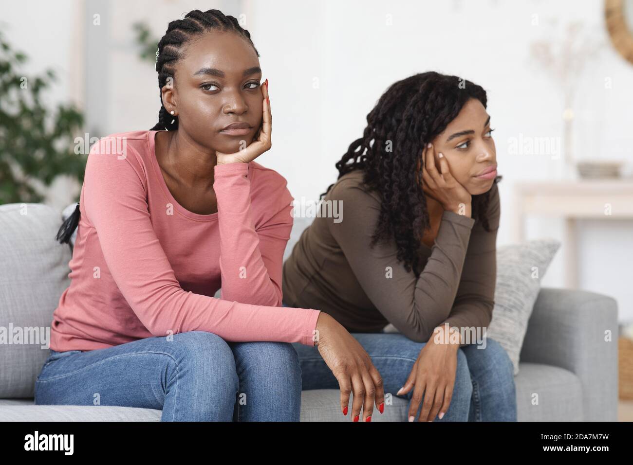 Two upset african women sitting on sofa, had quarrel Stock Photo - Alamy