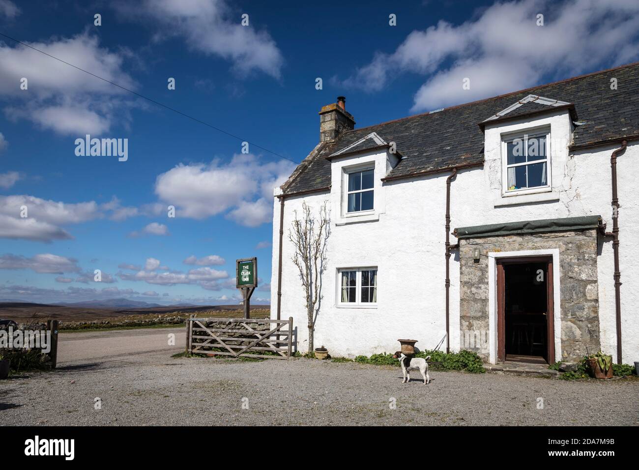 A dog awaits visitors to the Crask Inn which dates from 1815 and is ...
