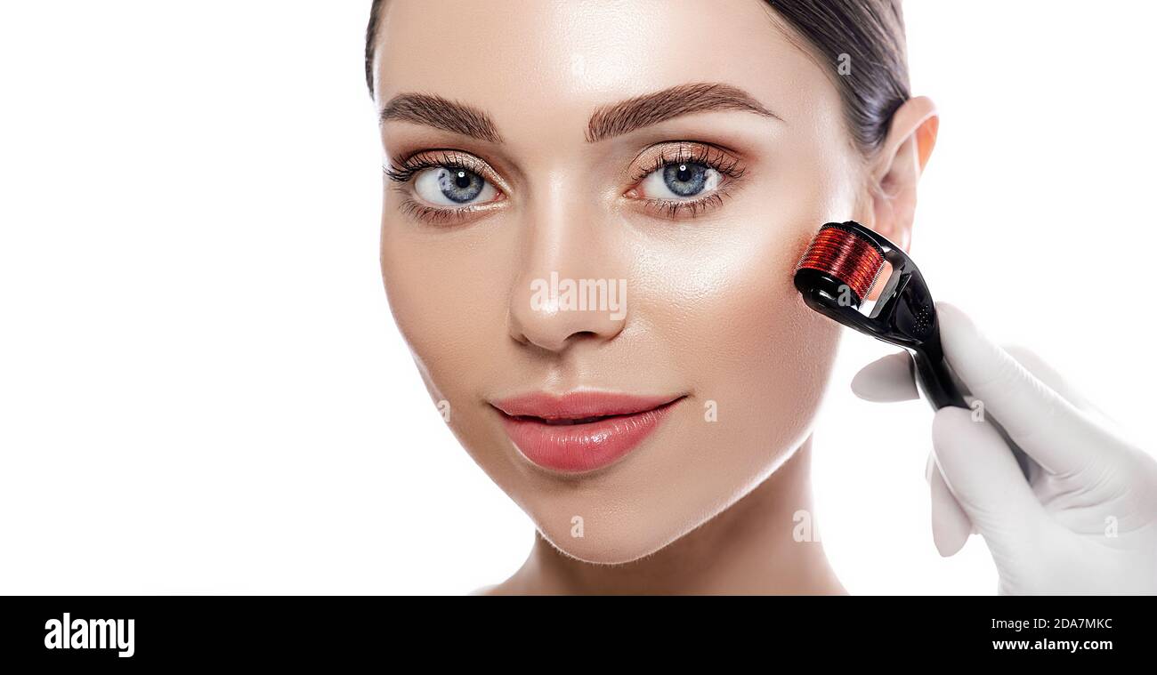 Beautiful woman during microneedling procedure. Beautician doing female ...