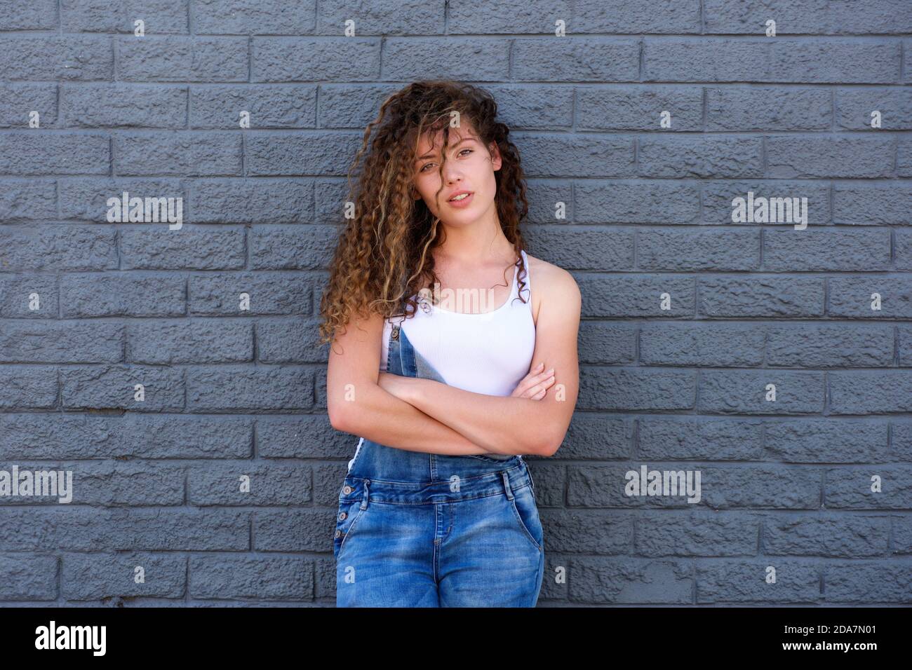 Portrait of serious girl standing with arms crossed and attitude Stock ...
