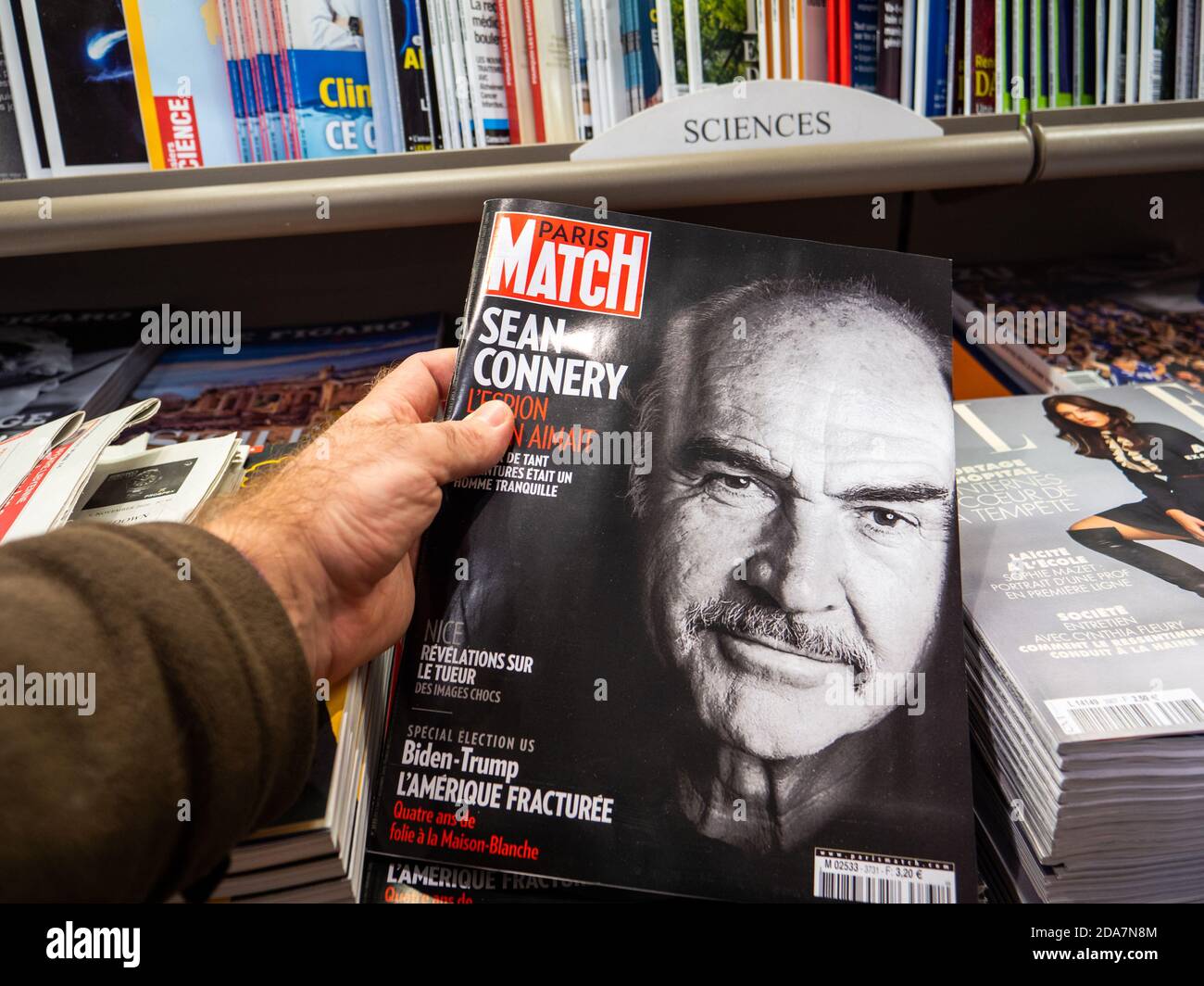Paris, France - Nov 9, 2020: POV male hand buying at press kiosk ...