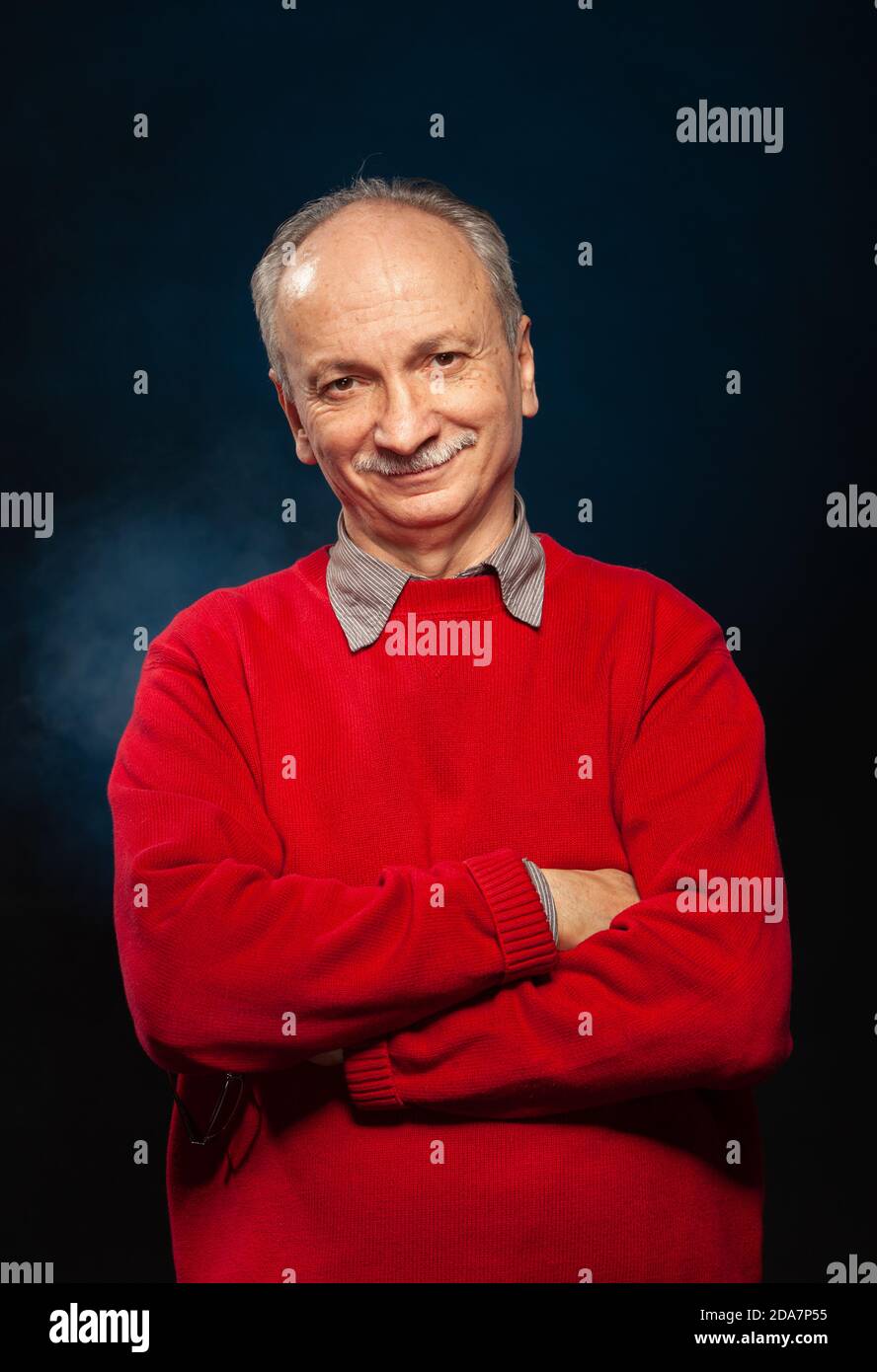 Old macho man. Portrait of an elderly emotional man on a dark ...