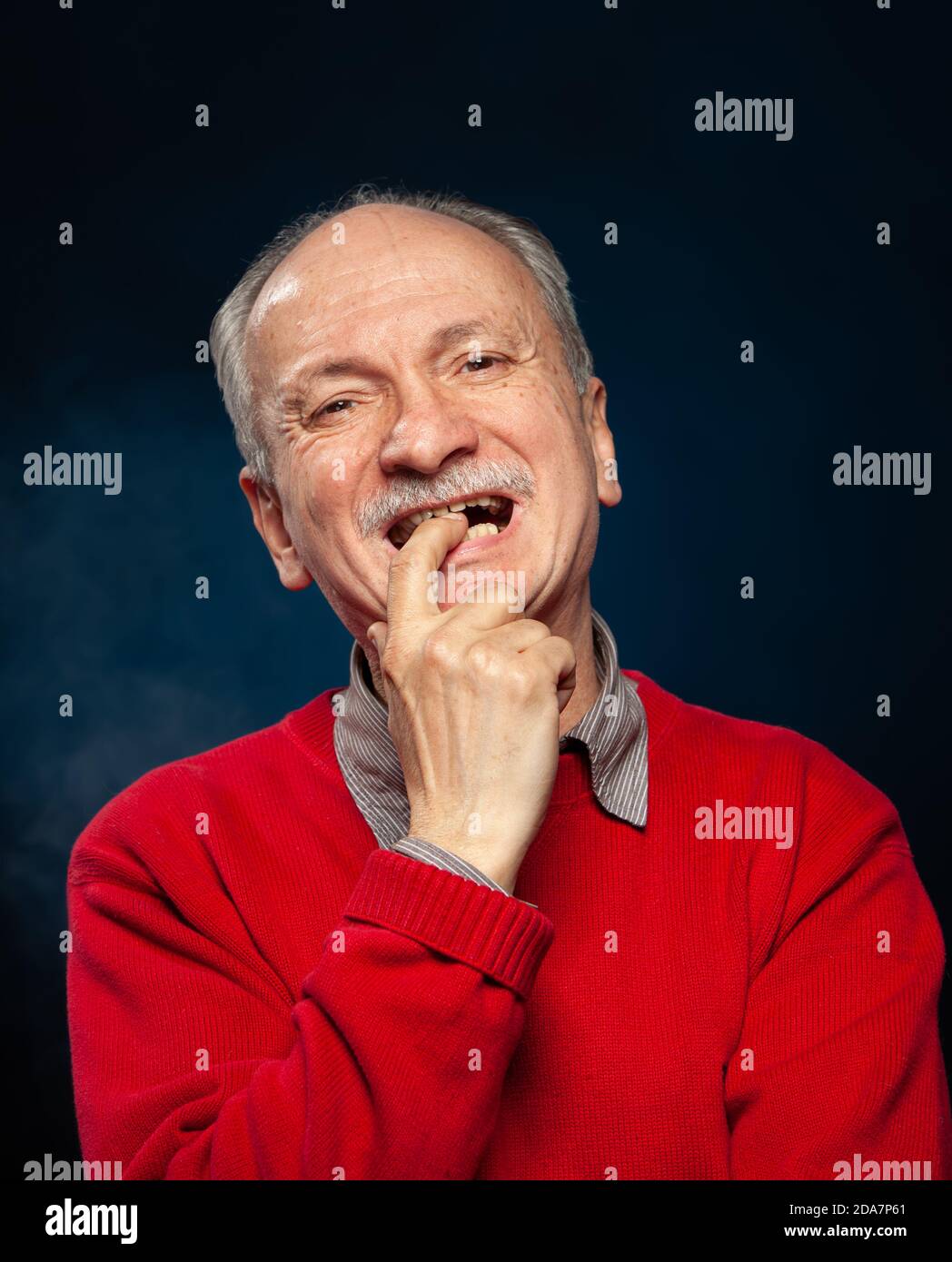 Old macho man. Portrait of an elderly emotional man on a dark ...