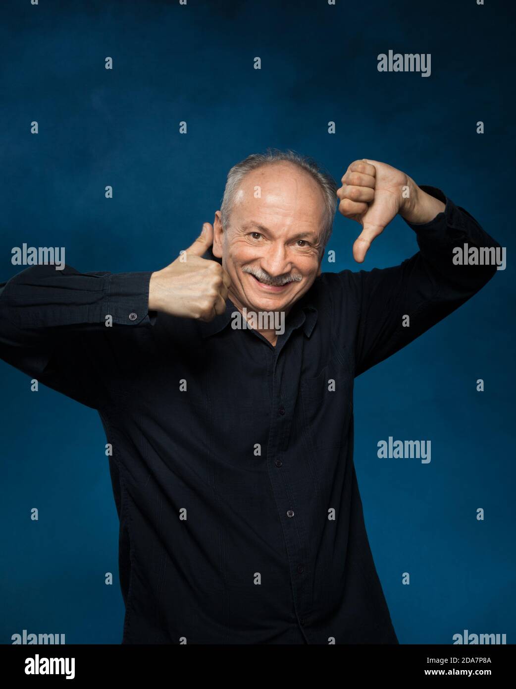 Old macho man. Portrait of an elderly emotional man on a dark ...