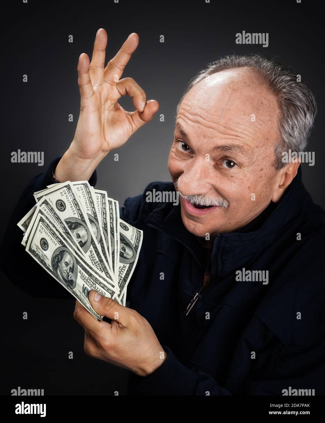 Senior gentleman holding a stack of money. Portrait of an excited old ...